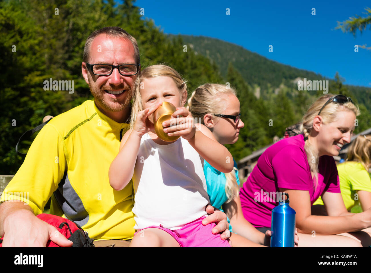 Family having break from hiking in the mountains Stock Photo - Alamy