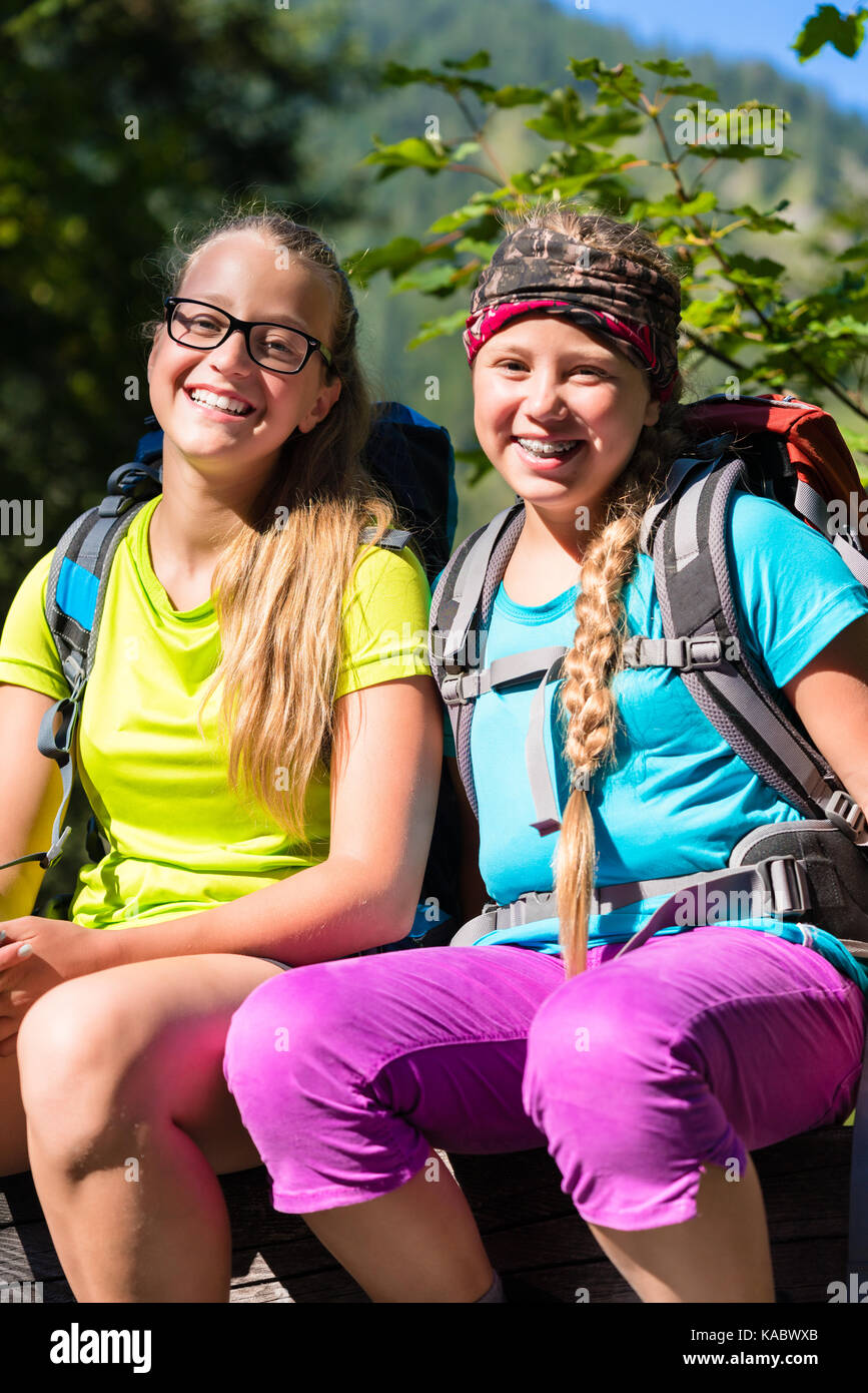 Friends or sisters hiking in the woods having fun Stock Photo - Alamy