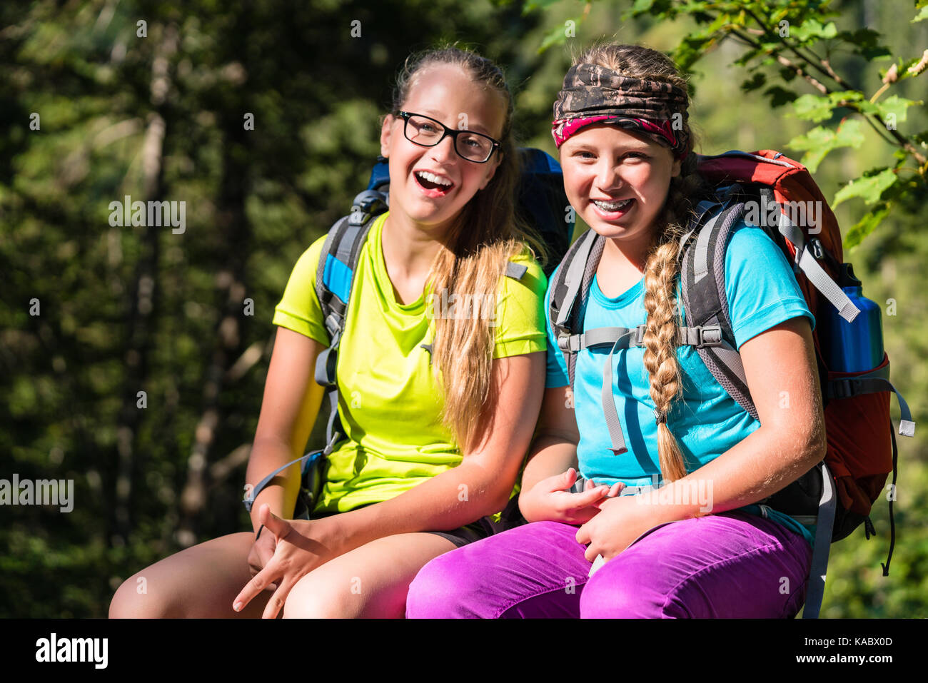 Friends or sisters hiking in the woods having fun Stock Photo - Alamy
