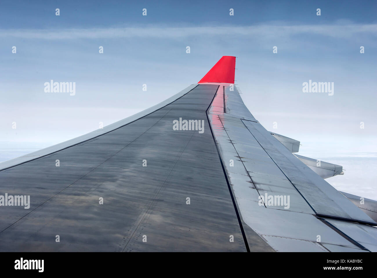wing of airplane from Air in the sky winglet red colored airline with ...
