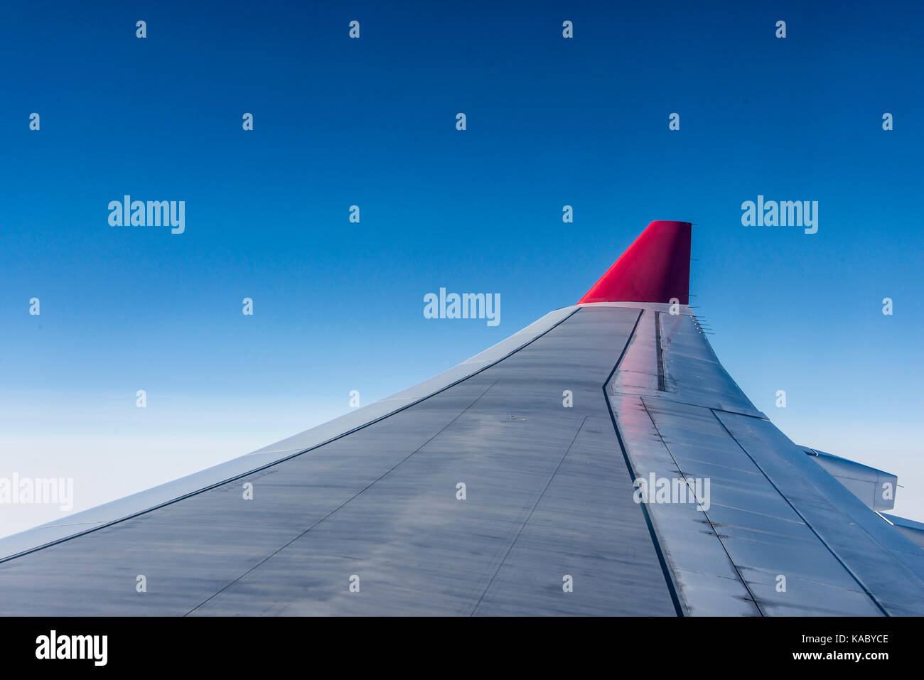 wing of airplane from Air in the sky winglet red colored airline with ...