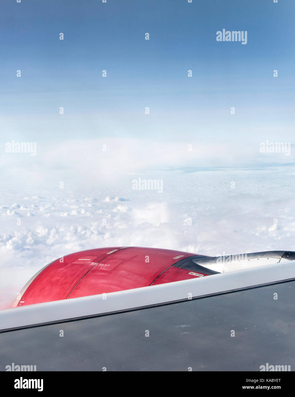 red jet engine turbine look through aircraft window on sunny day blue ...