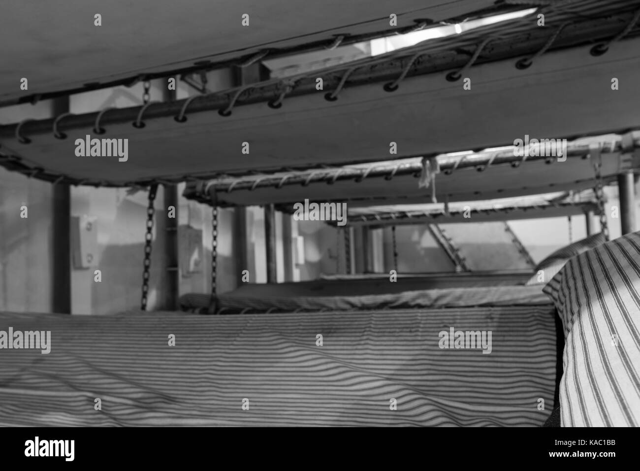 Rows of beds inside WWII Liberty Ship troop transporter in black and ...