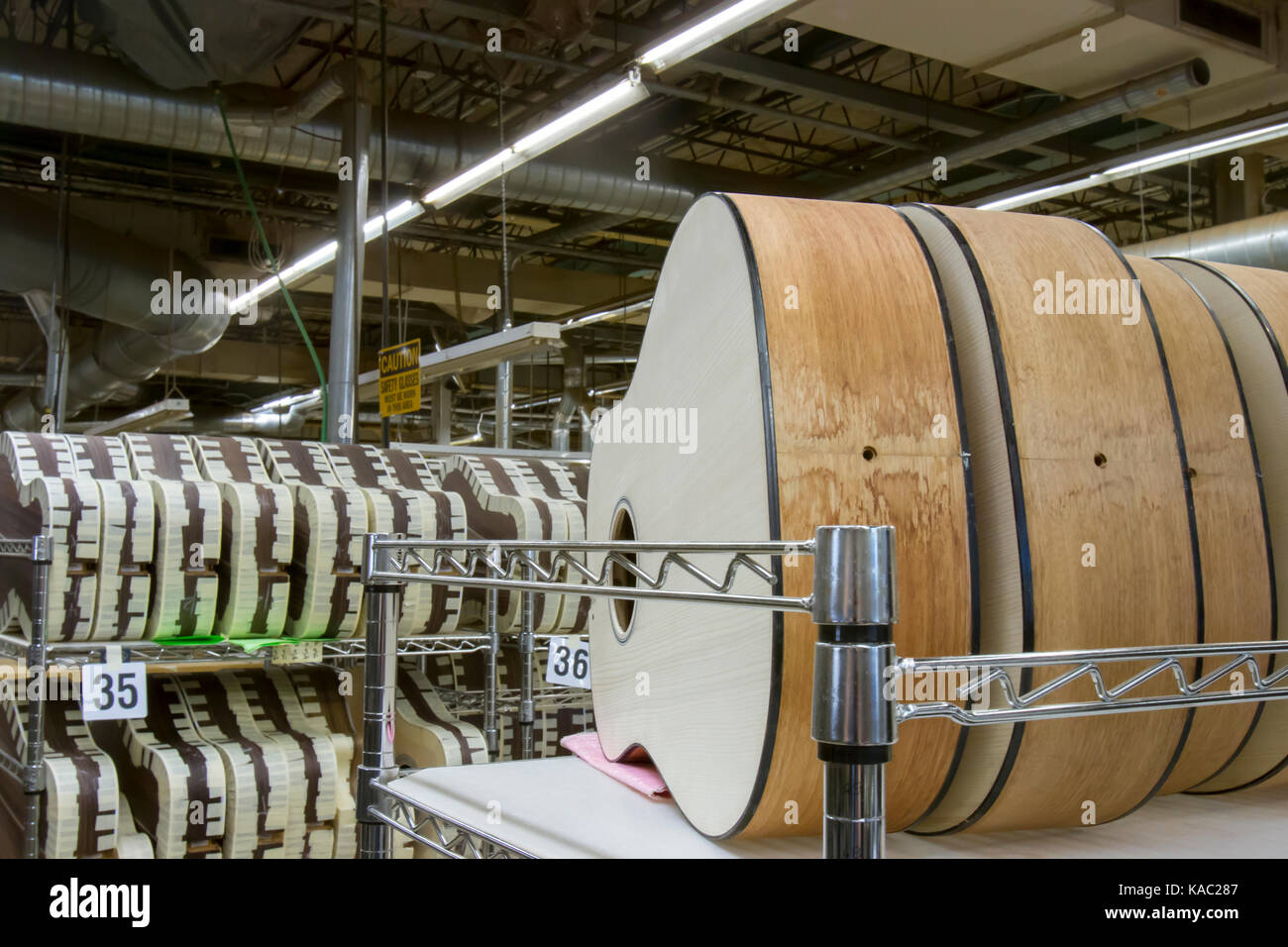 Unfinished bodies of wooden acoustic guitars in factory Stock Photo - Alamy