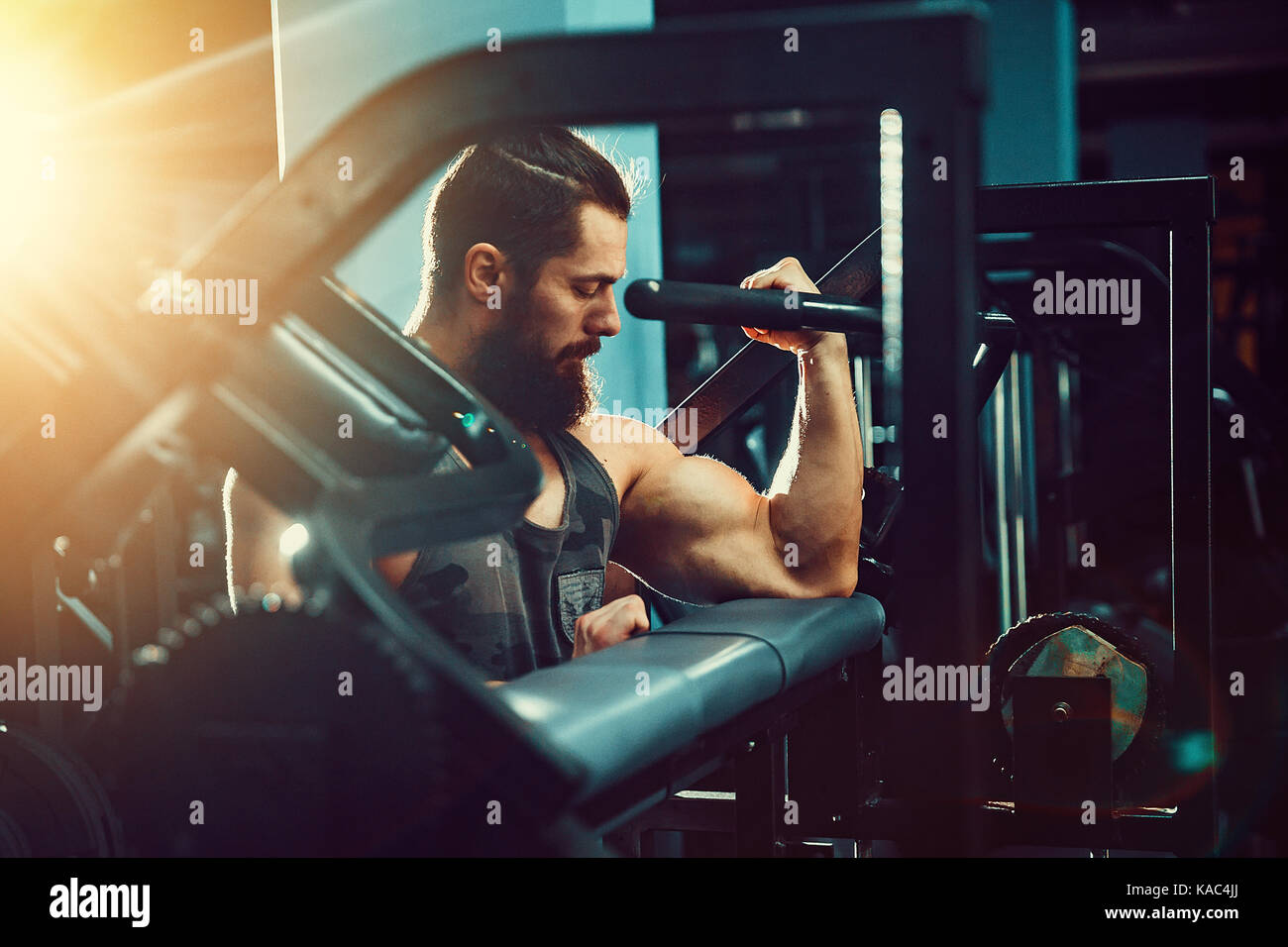 Man Doing Heavy Weight Exercise For Biceps On Machine In A Gym Stock ...