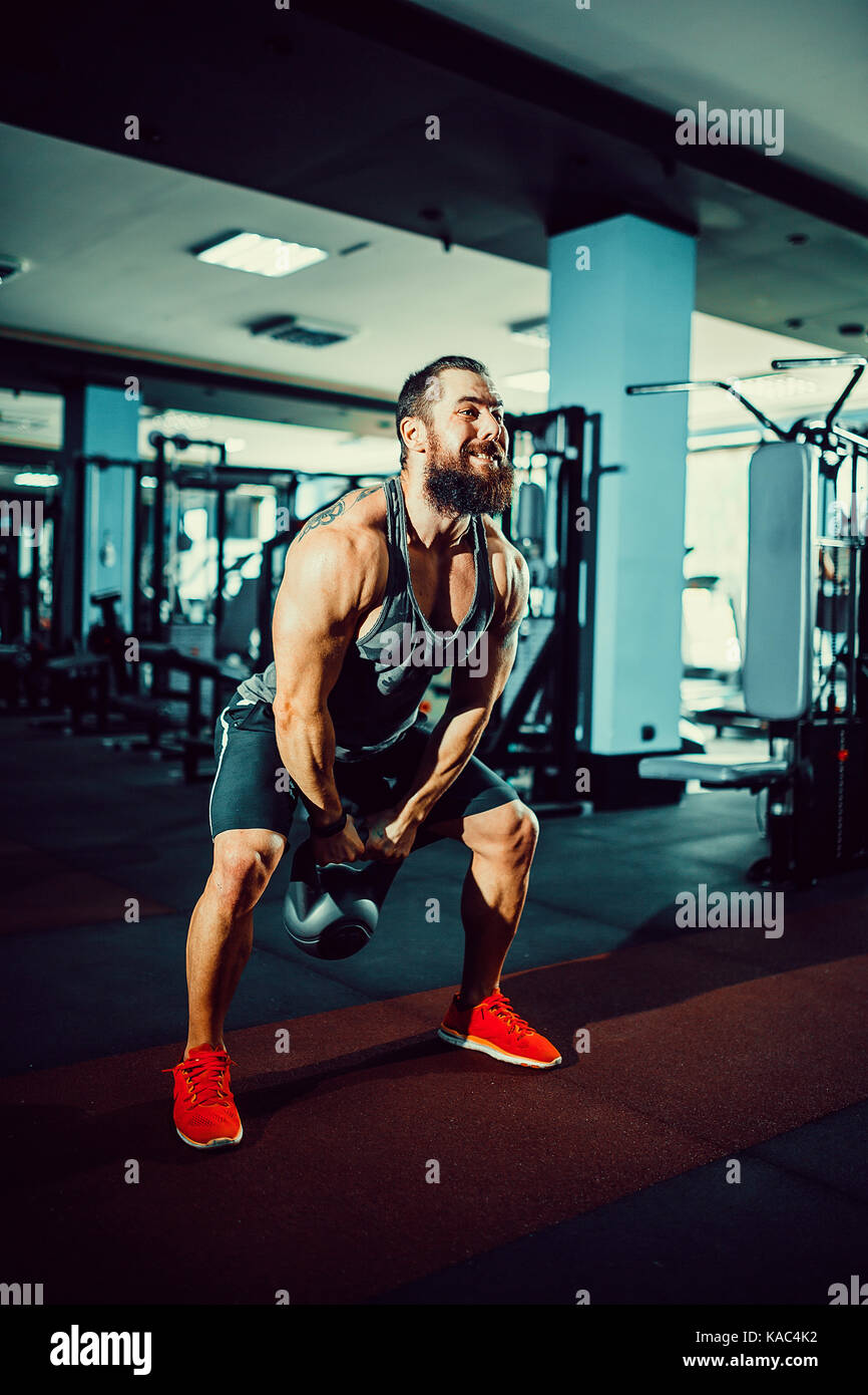 Fitness Kettlebells swing exercise man workout at gym Stock Photo - Alamy