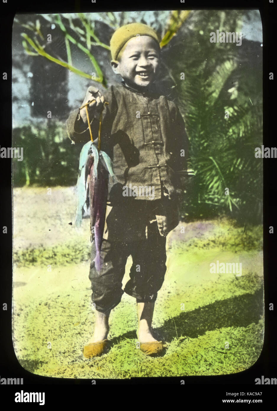 Smiling child holding fish, China, ca. 1918 1938 (MFB LS0232 Stock ...