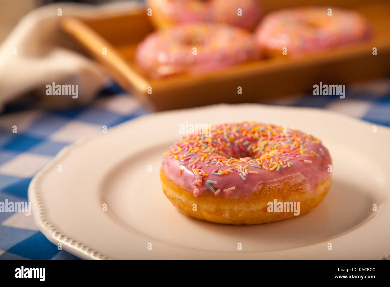 sprinkled doughnut on white plate Stock Photo - Alamy