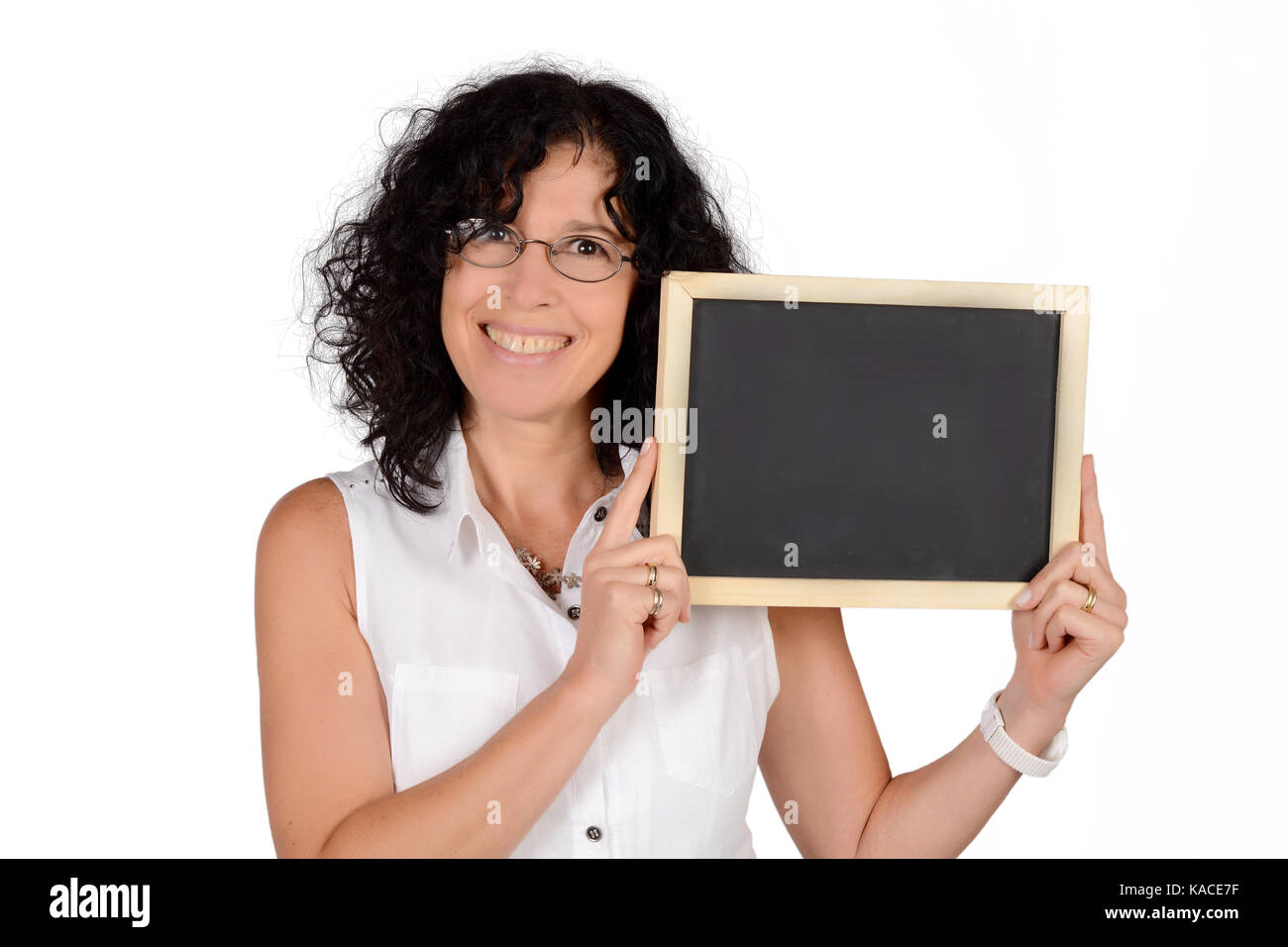 Portrait of beautiful school teacher holding an empty chalkboard ...