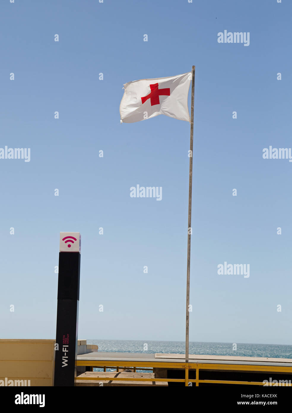Red cross flag against a blue sky Stock Photo - Alamy
