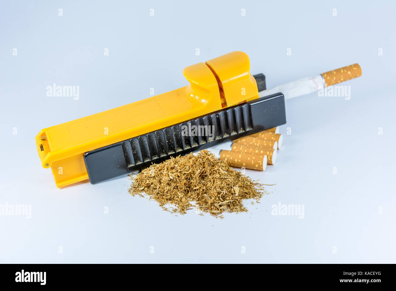 Cigarette rolling machine and empty cigarette tubes Stock Photo - Alamy