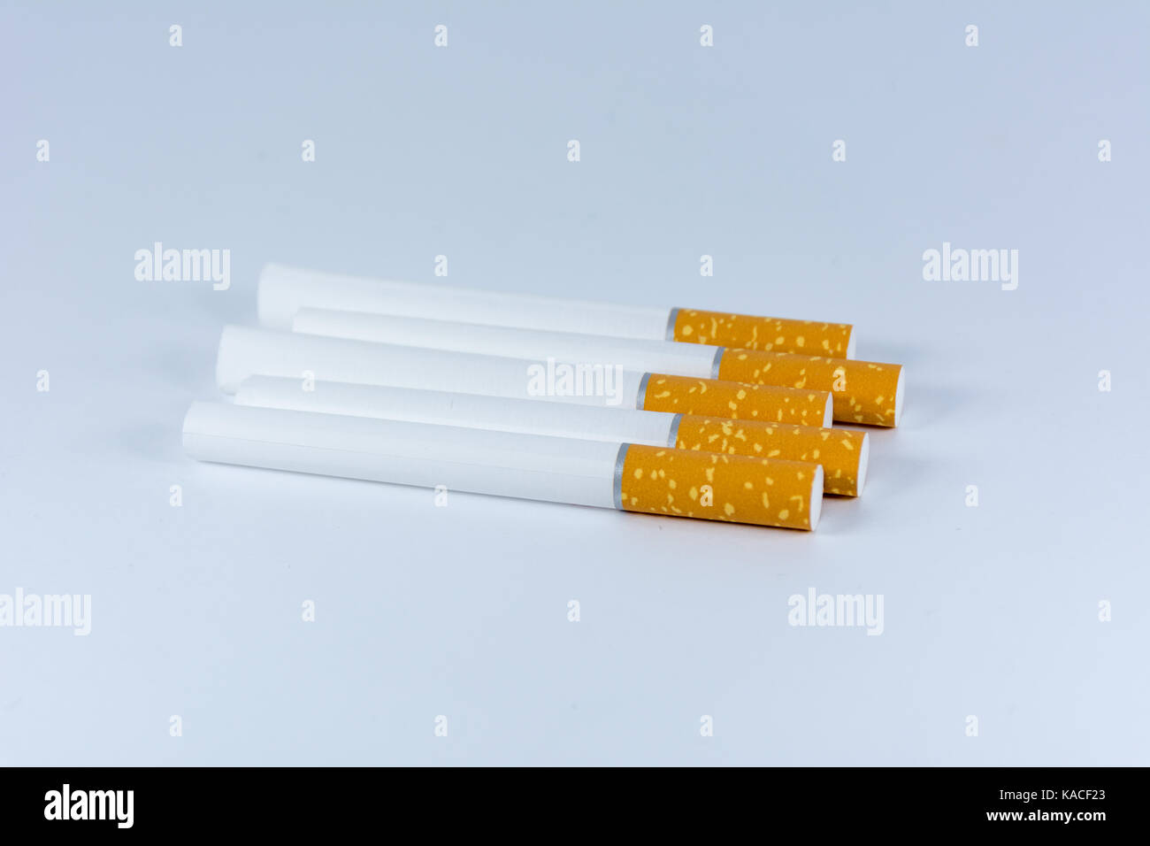 Empty cigarette tubes on white background isolated Stock Photo - Alamy