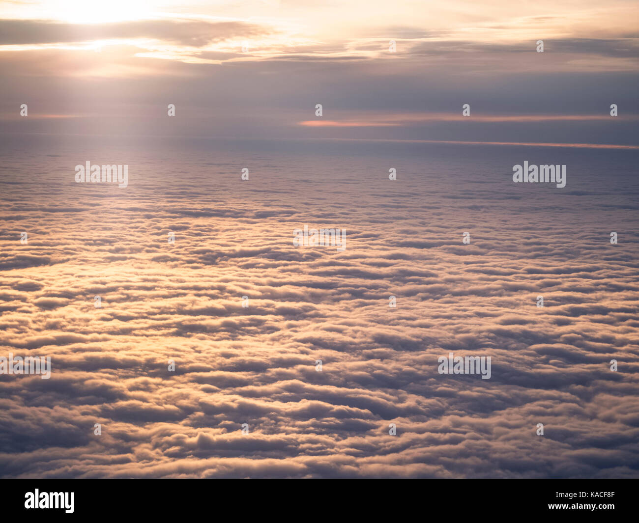 Aerial view above the clouds with a beautiful sunset over North ...