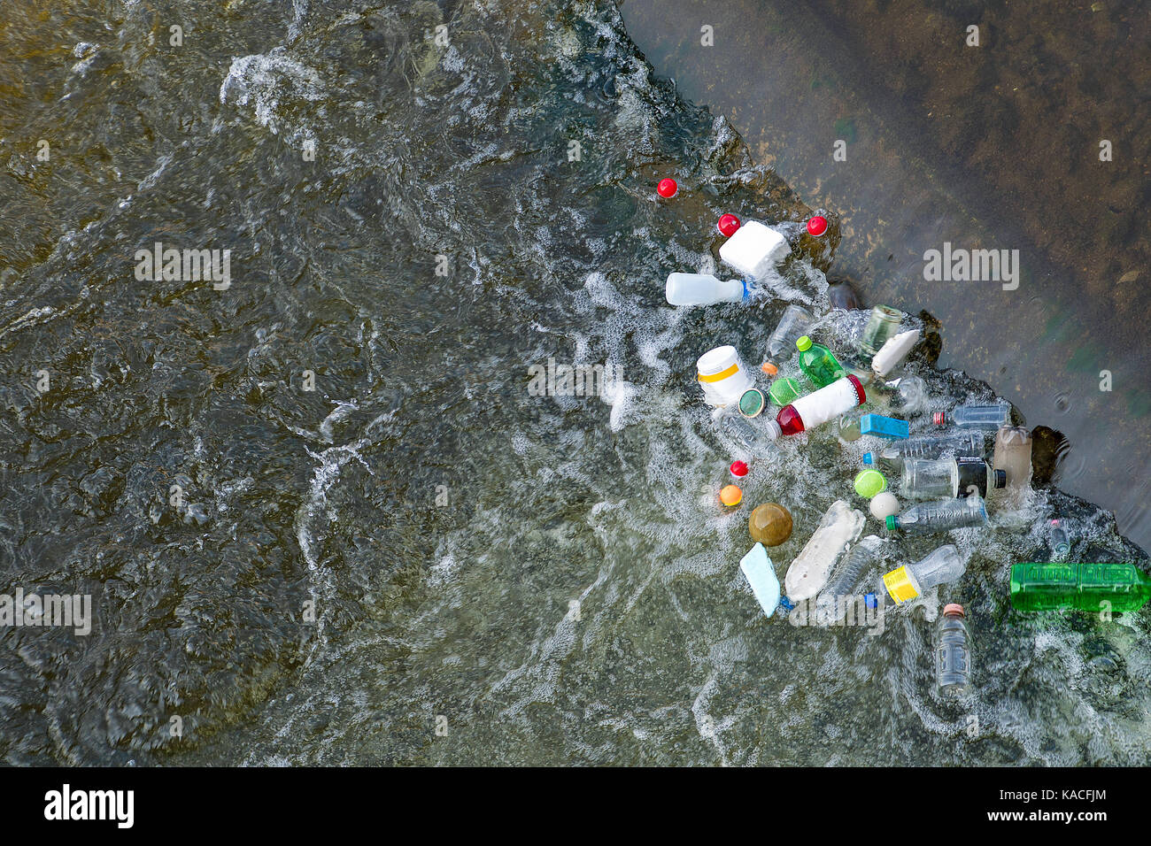 discarded trash floating in river water Stock Photo - Alamy