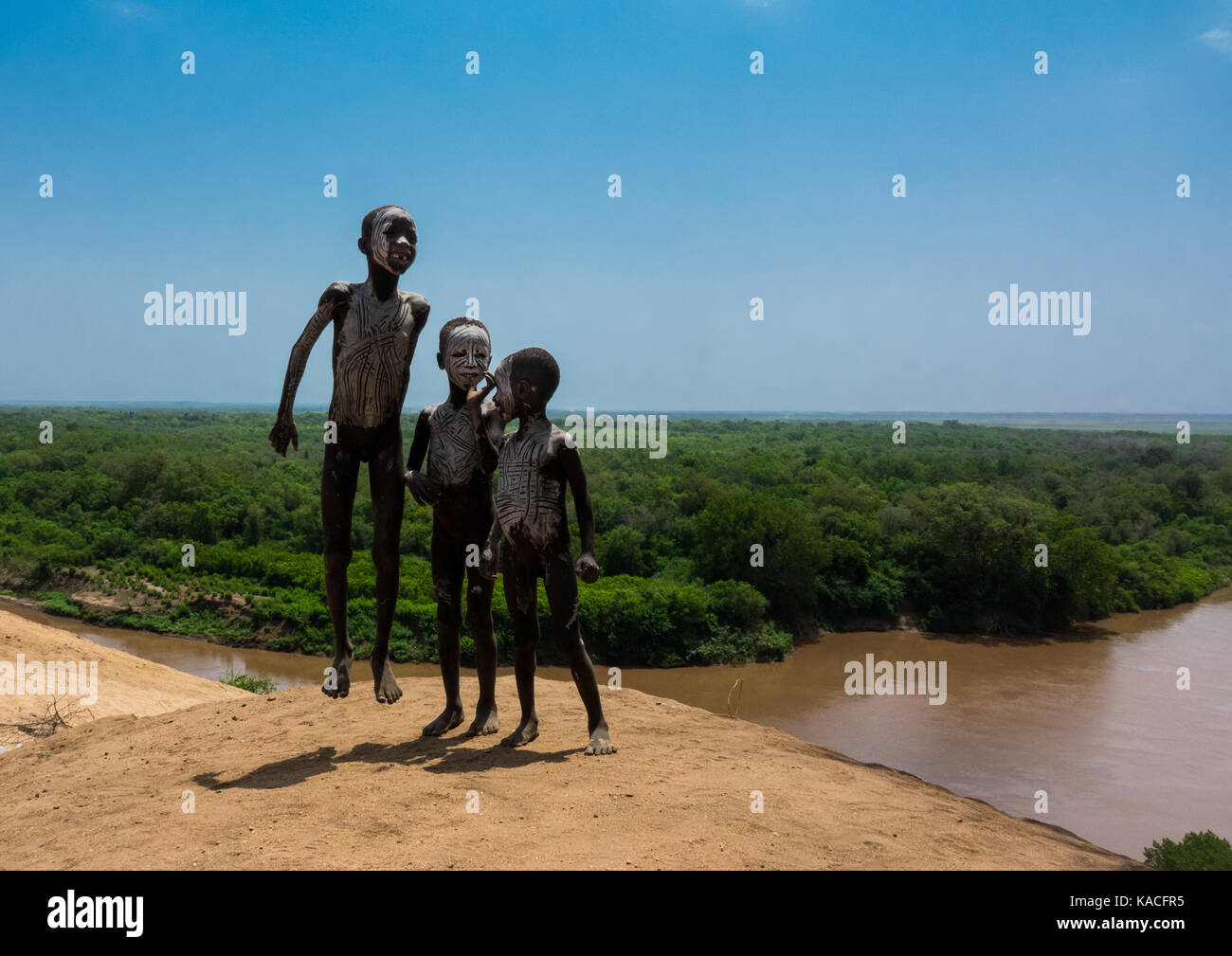 Karo tribe kids jumping in front of Omo river, Omo valley, Korcho ...