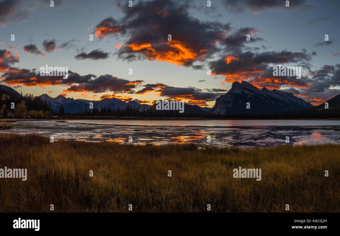 Sunrise over a Lake with Mountains in Shadow Stock Photo - Alamy