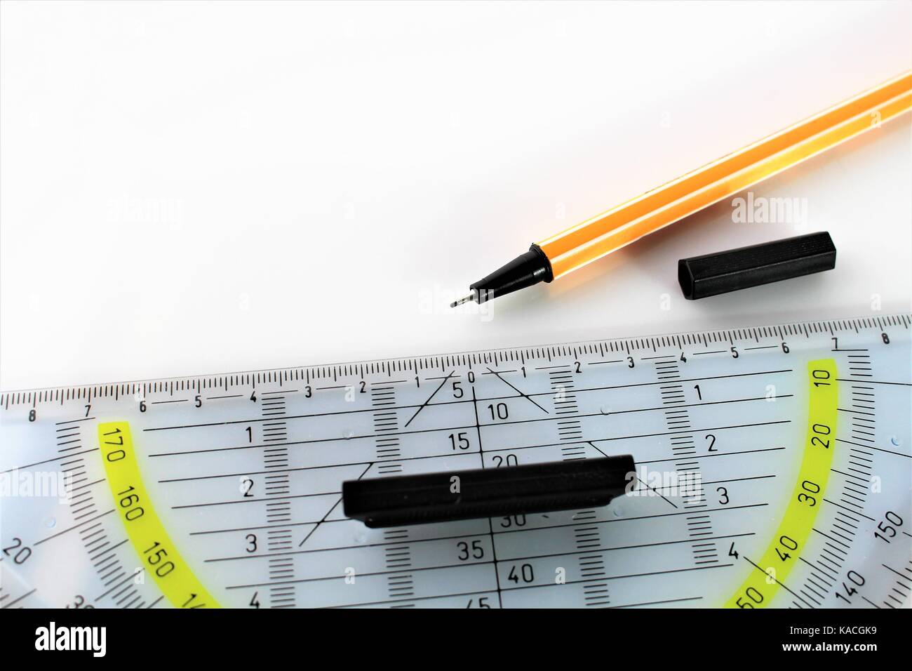 An image of a triangle ruler and a pen - office, school Stock Photo - Alamy