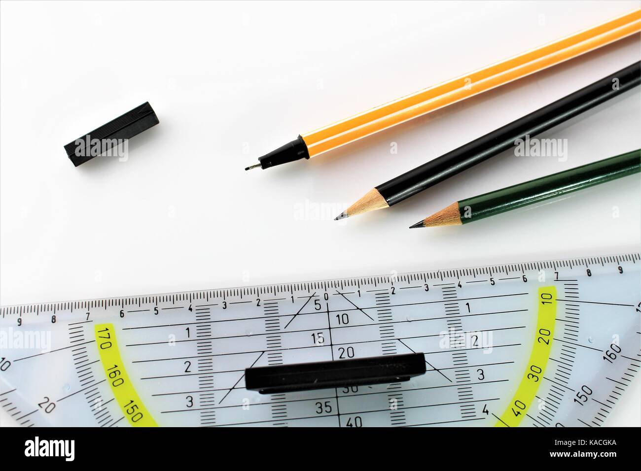 An image of a triangle ruler and a pen - office, school Stock Photo - Alamy