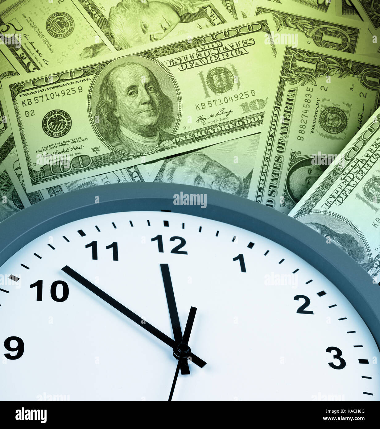 Clock on assorted American banknotes. Time is money idea Stock Photo ...