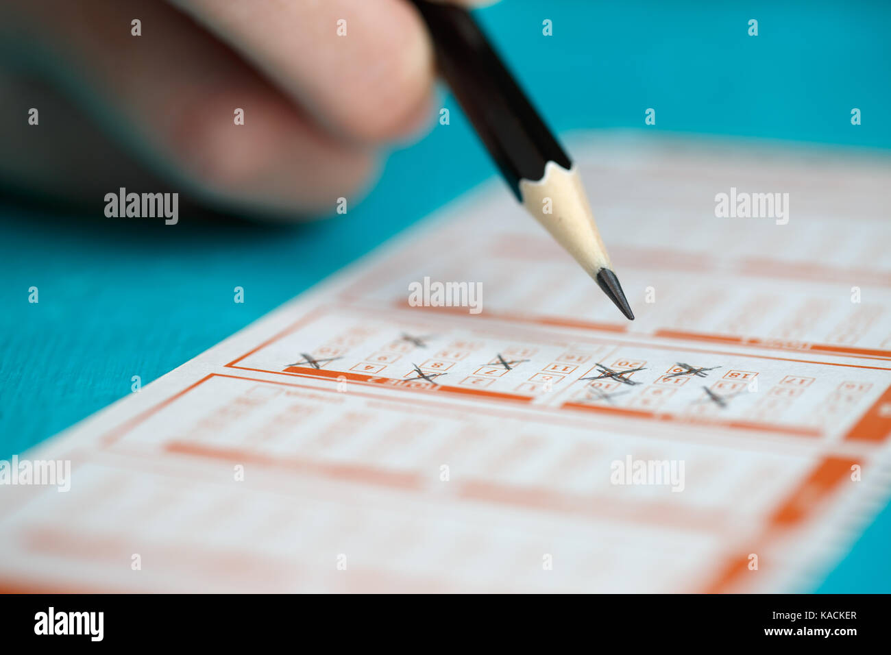 Picture of man's hand with pencil marking in lottery ticket Stock Photo ...