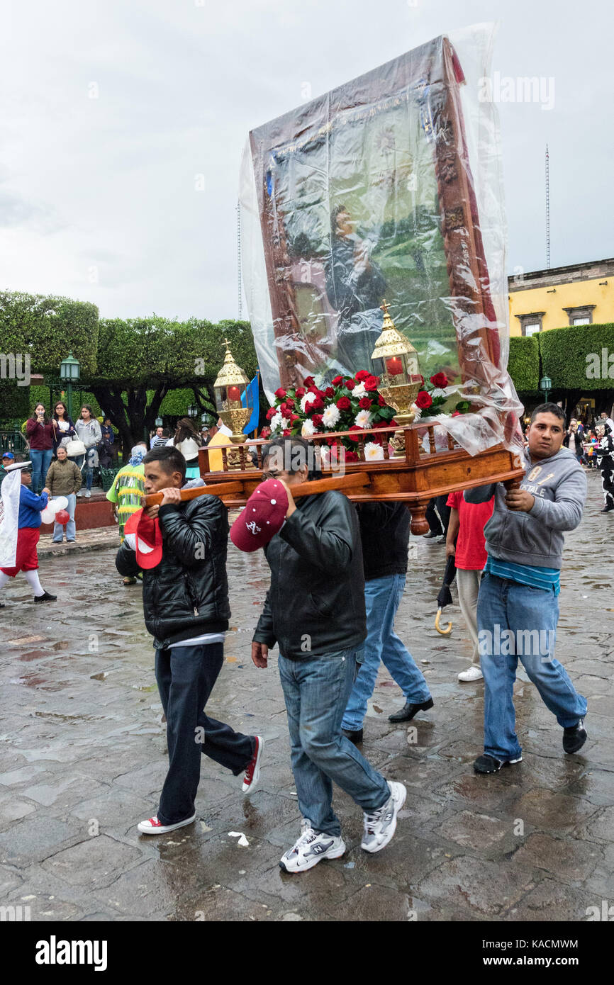 Men carry a religious icon during a procession through the Jardin ...