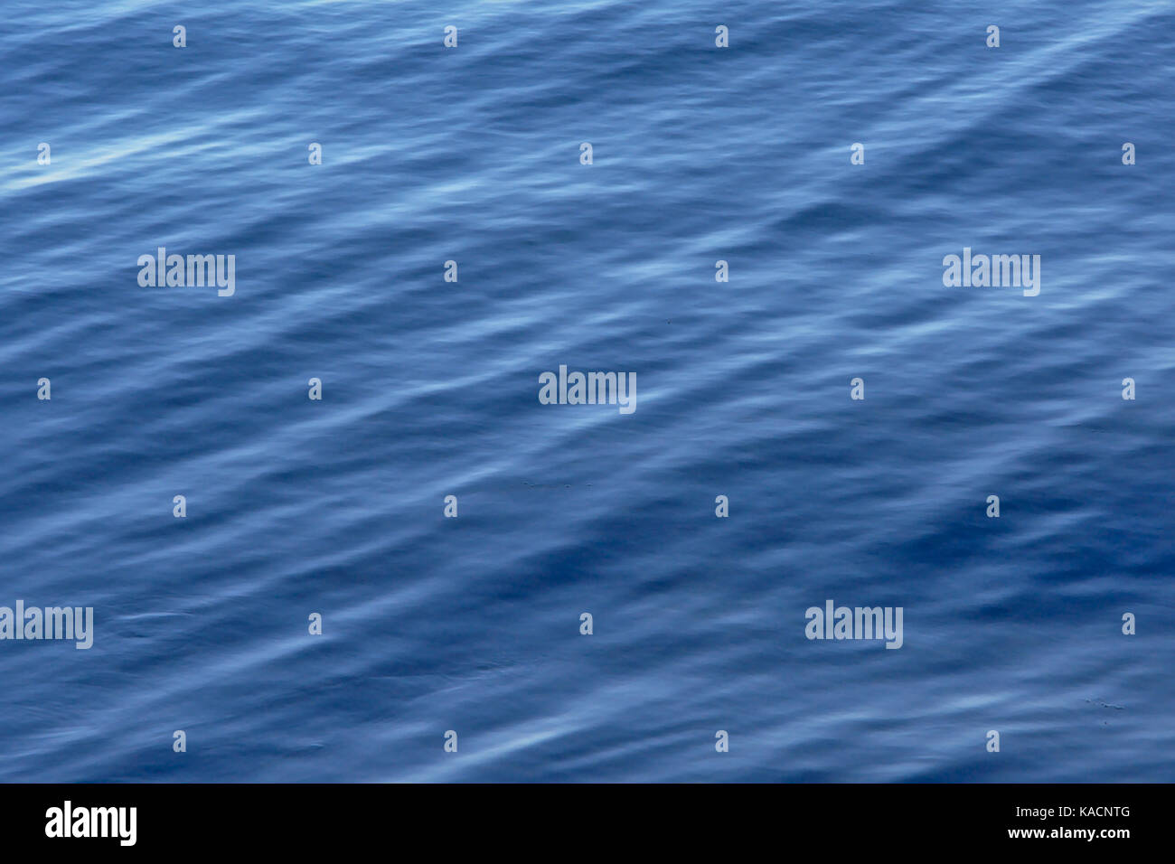 Background of water surface with gentle waves moving across Stock Photo ...