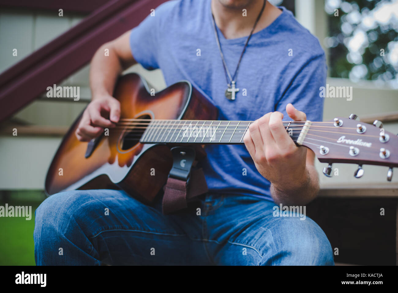 A young man plays a guitar Stock Photo - Alamy