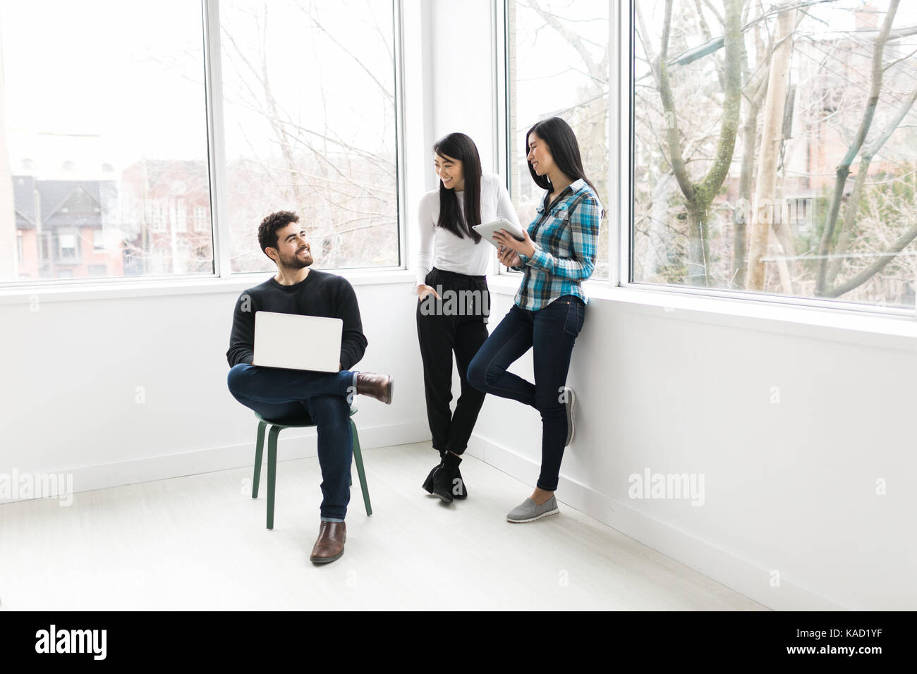 Young business people collaborating Stock Photo - Alamy