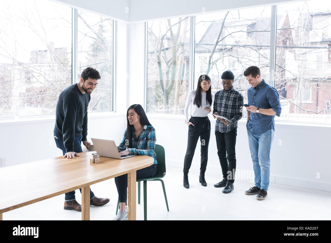 Young business people collaborating Stock Photo - Alamy