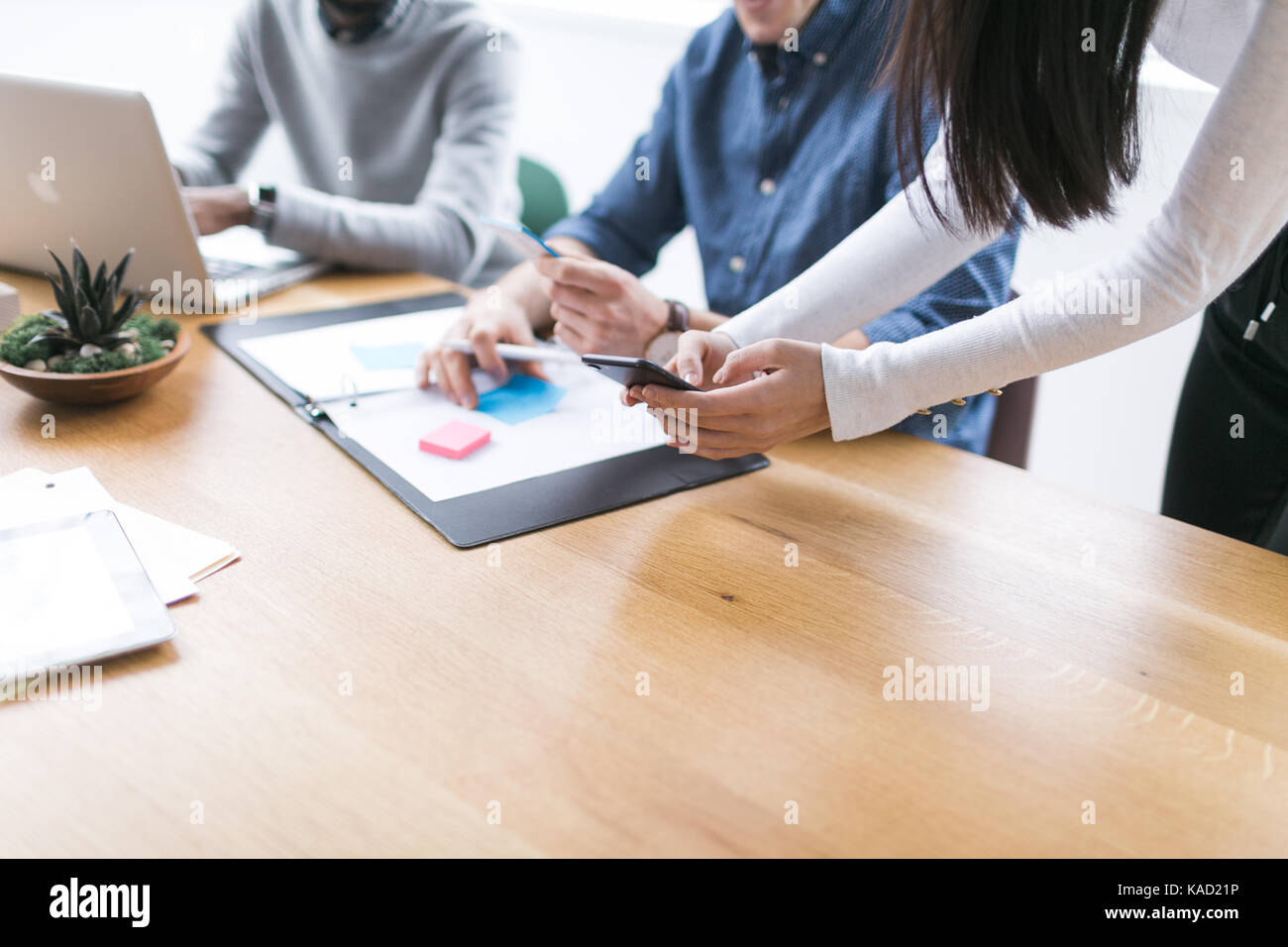 Young business people collaborating Stock Photo - Alamy