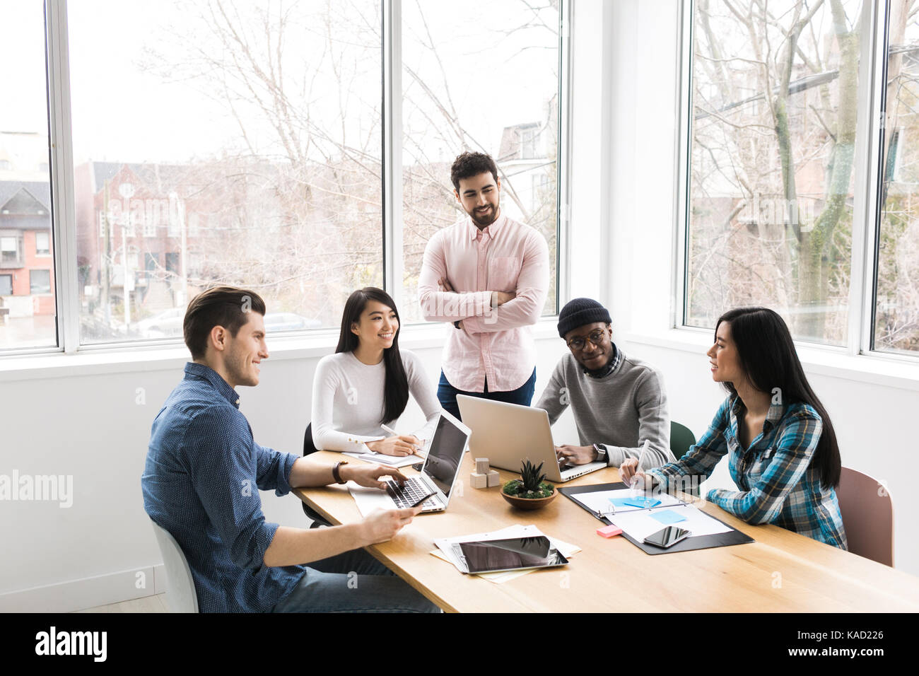Young business people collaborating Stock Photo - Alamy