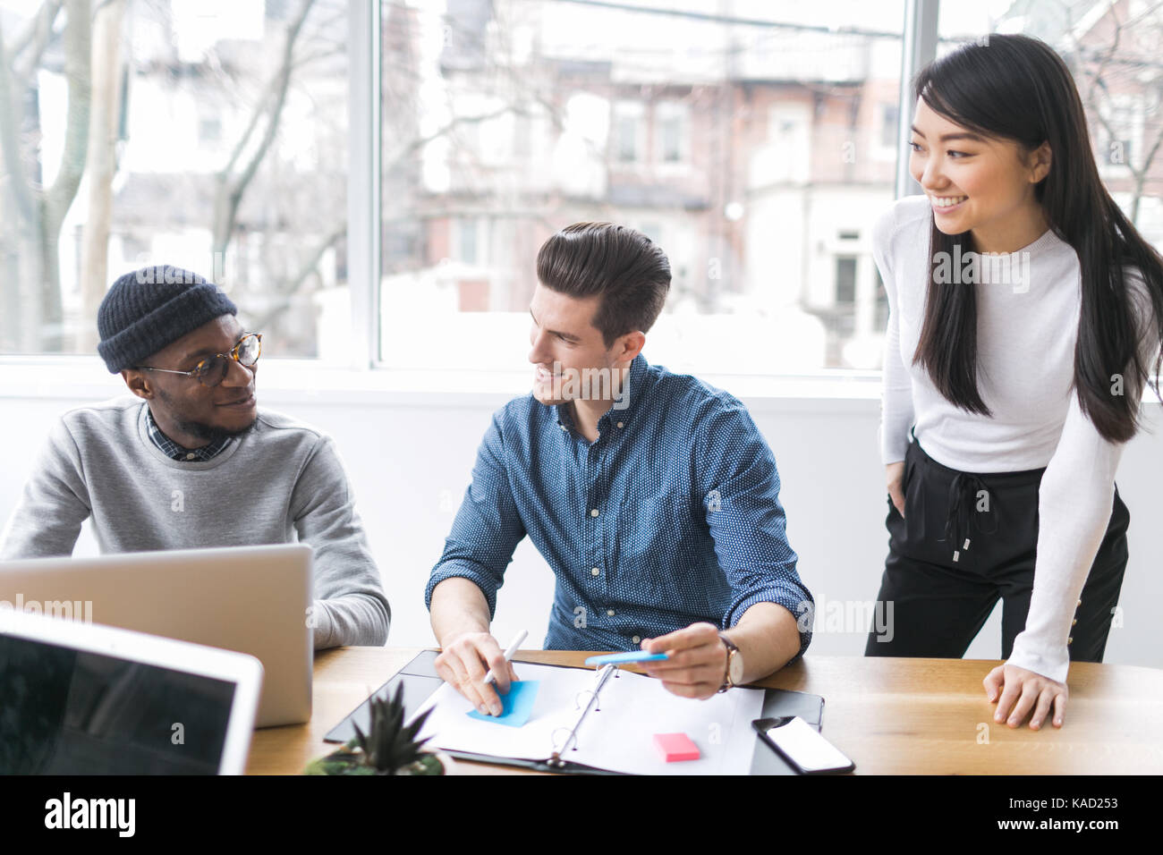 Young business people collaborating Stock Photo - Alamy