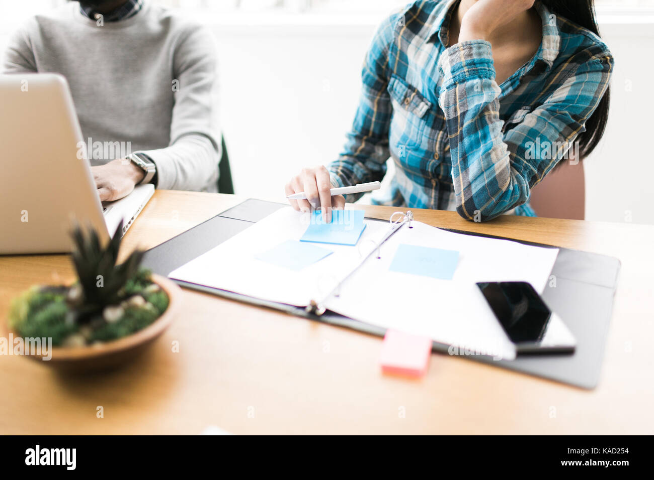 Young business people working on a project Stock Photo - Alamy