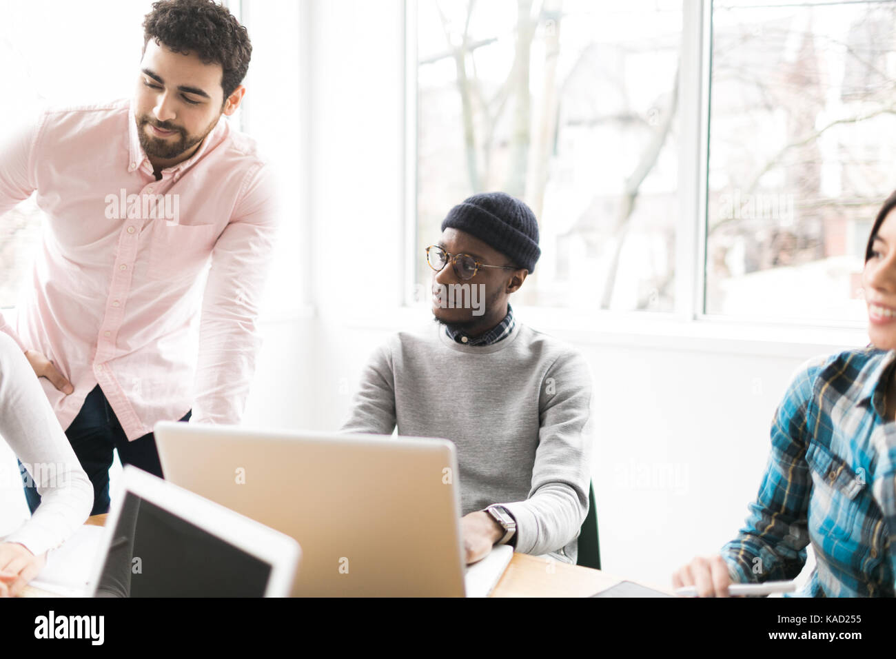 Young business people collaborating Stock Photo - Alamy