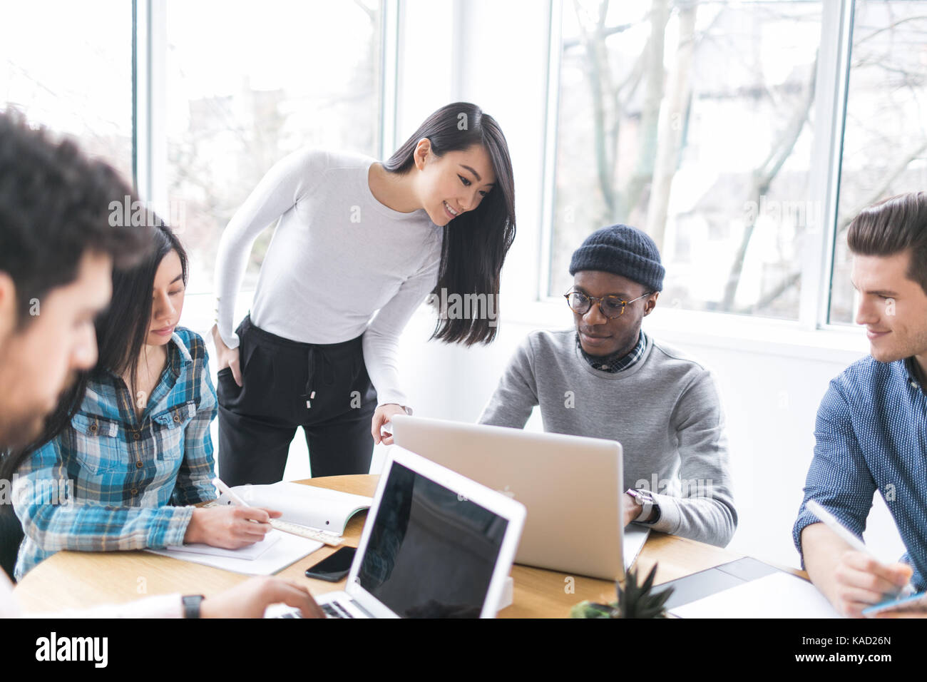 Young business people collaborating Stock Photo - Alamy