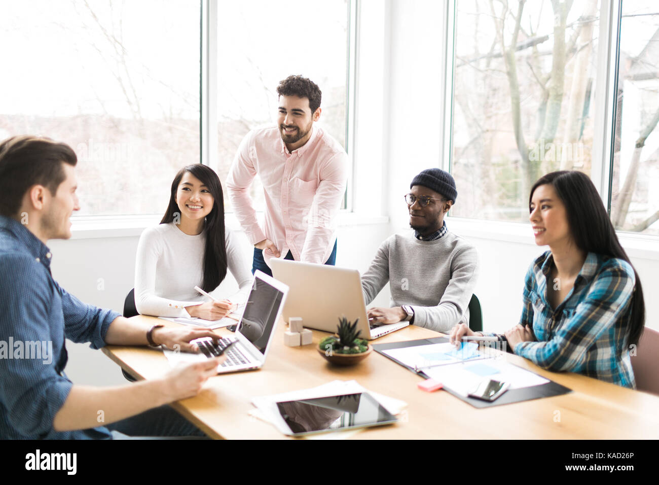 Young business people collaborating Stock Photo - Alamy