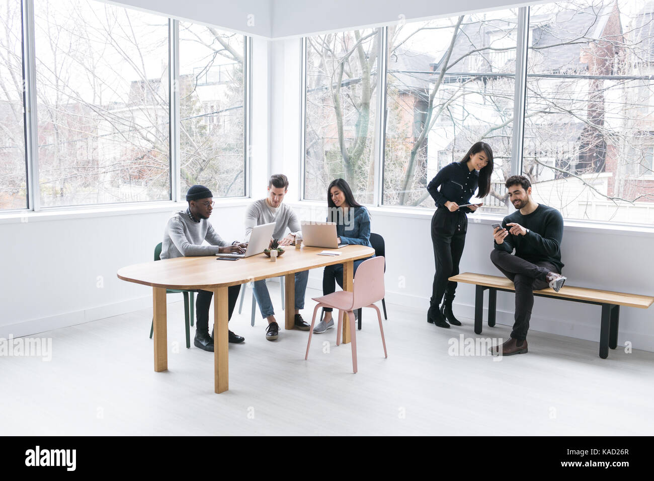Young business people collaborating Stock Photo - Alamy