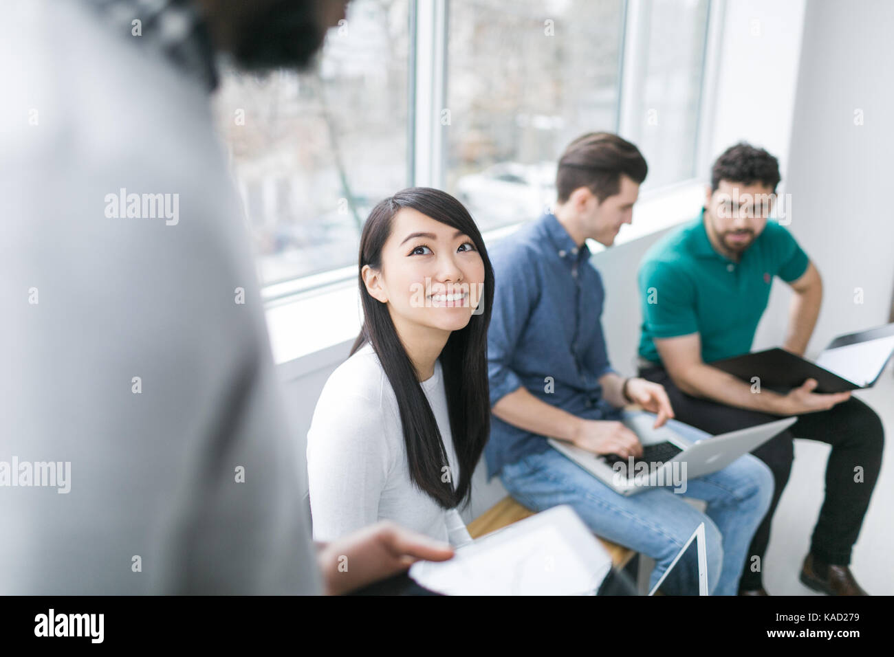 Young business people collaborating Stock Photo - Alamy