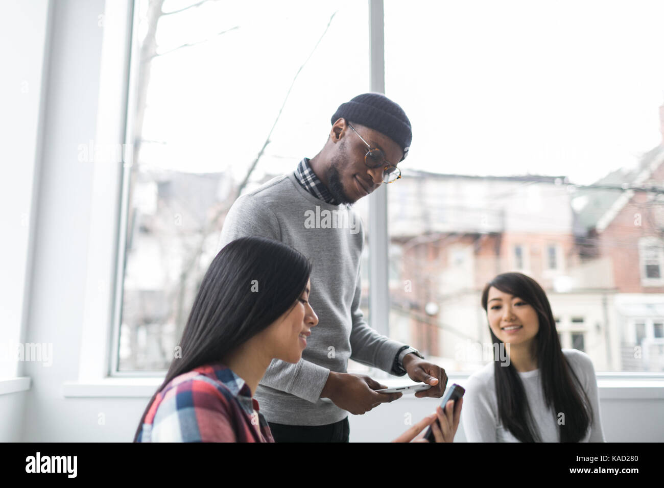Young business people collaborating Stock Photo - Alamy