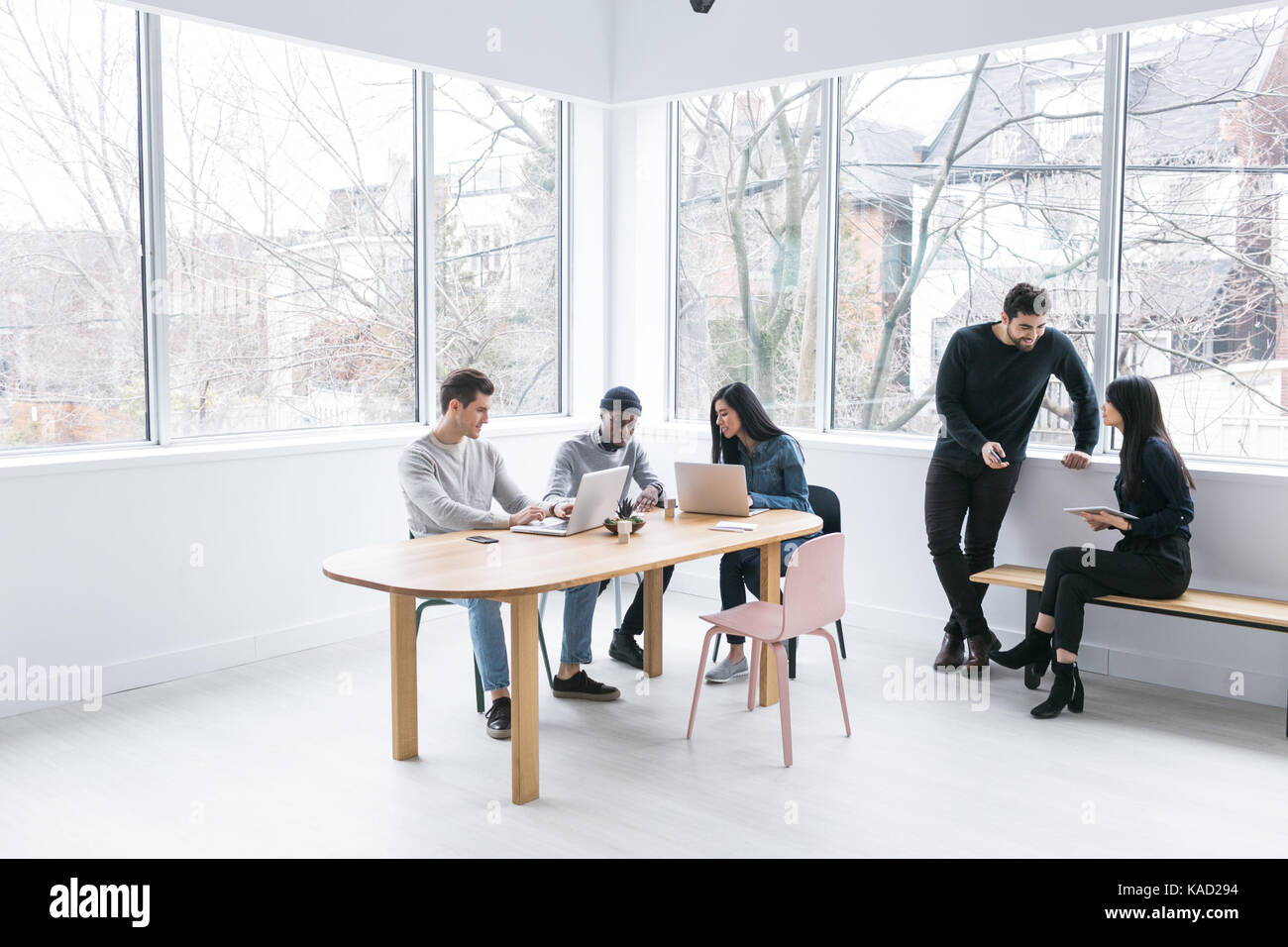Young business people collaborating Stock Photo - Alamy
