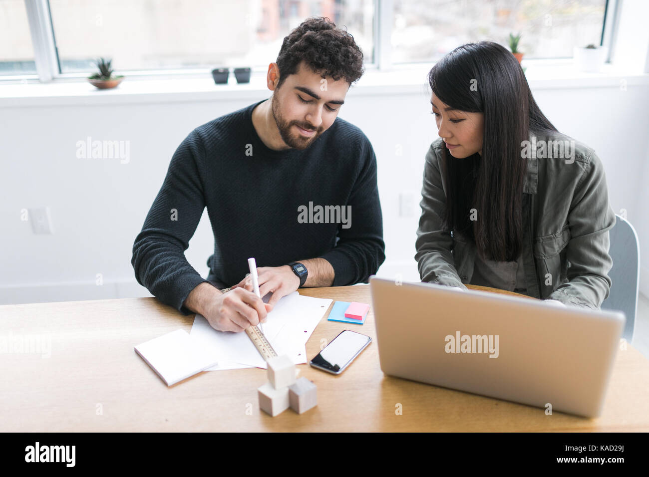 Young business people working on a project Stock Photo - Alamy