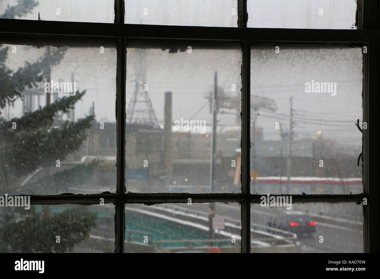 Cloudy winter day in an industrial area, viewed through office window ...