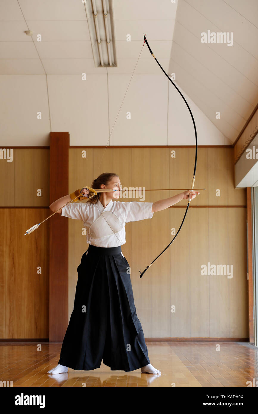 Caucasian woman practicing traditional Kyudo Japanese archery Stock ...