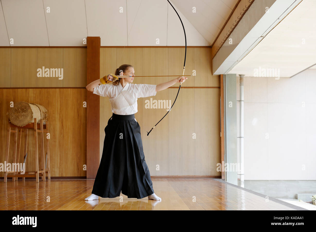 Caucasian woman practicing traditional Kyudo Japanese archery Stock ...