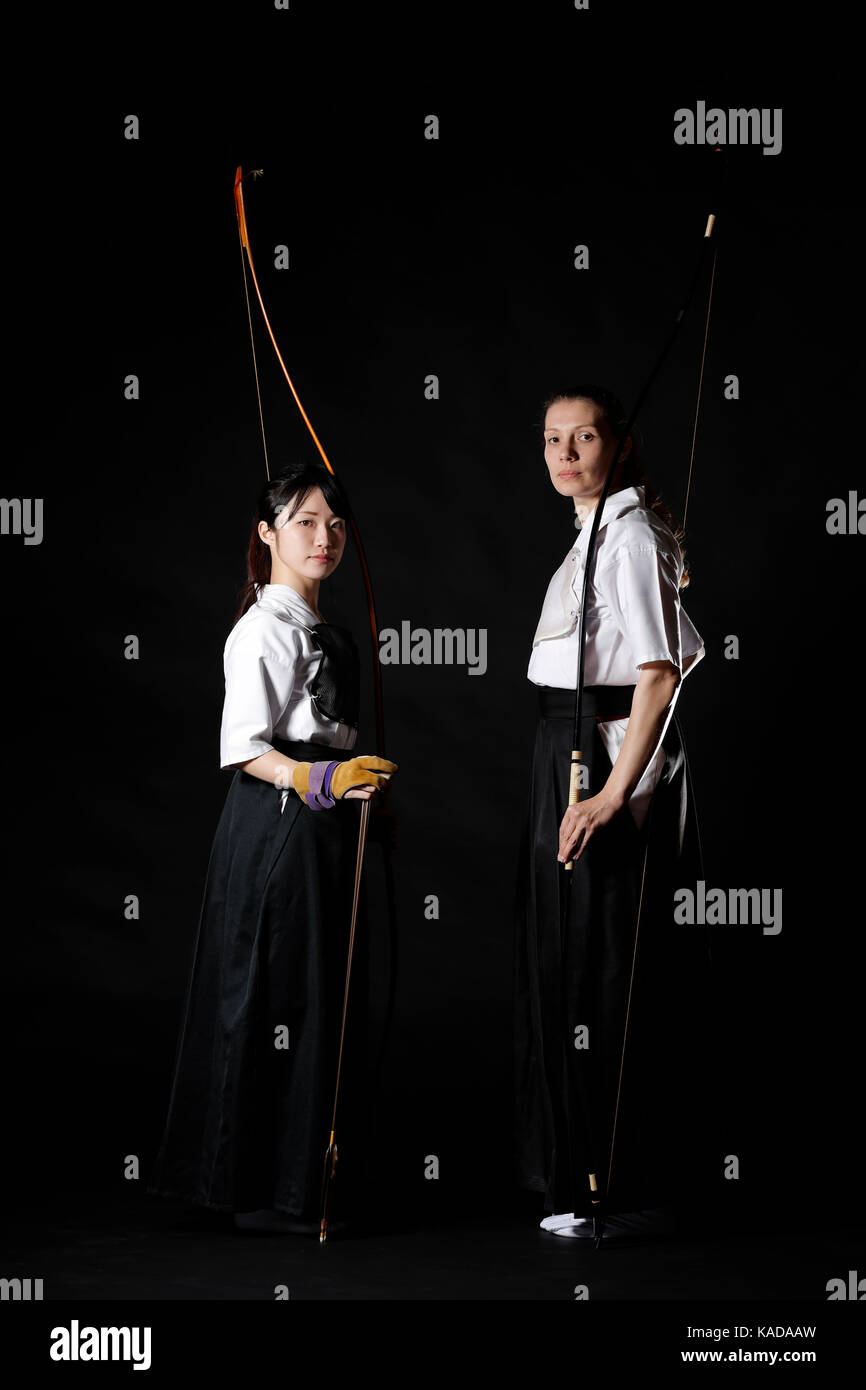 Multi-ethnic traditional Kyudo Japanese archery athletes on black ...