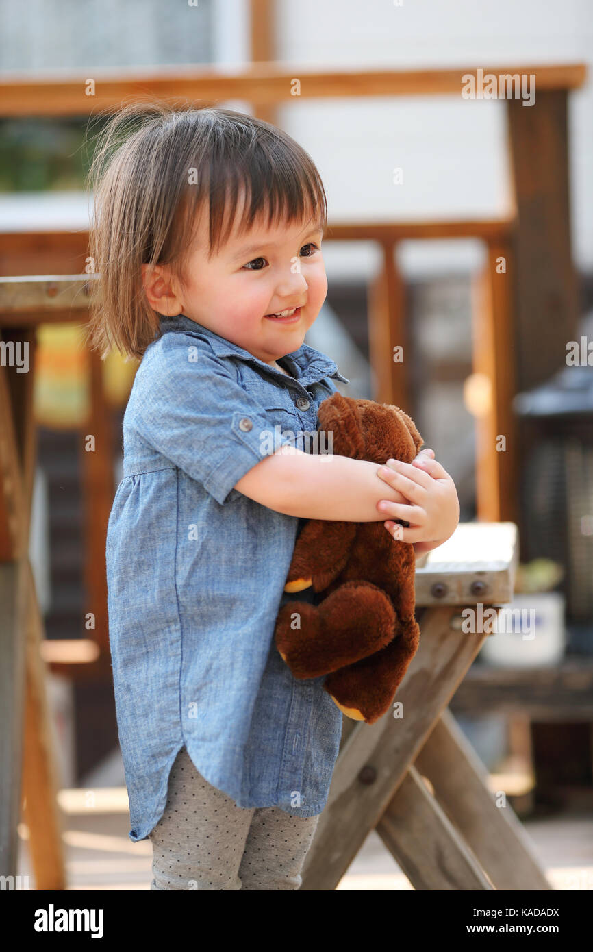 Mixed-race young girl with teddy bear Stock Photo - Alamy