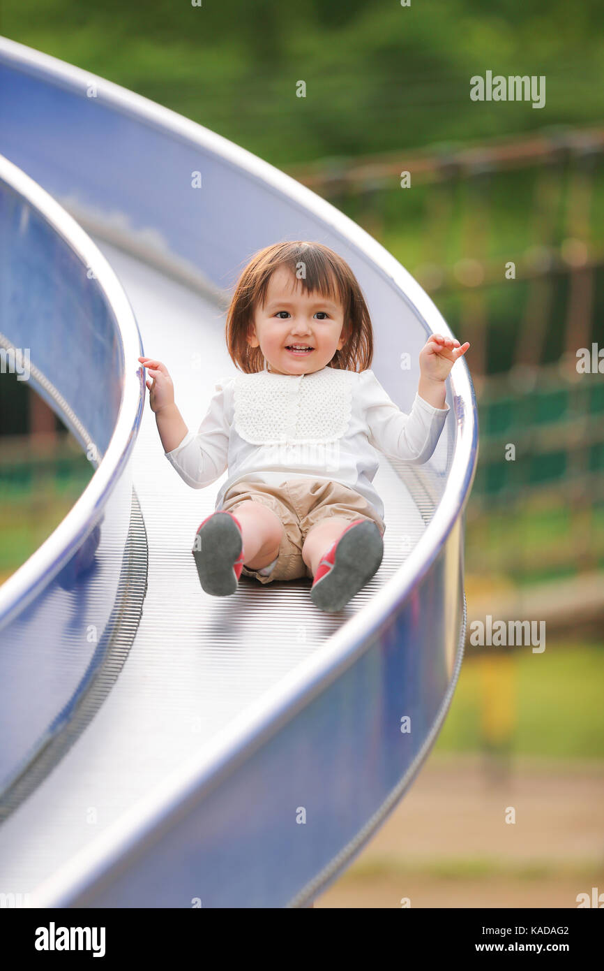 Girl playing on slide hi-res stock photography and images - Alamy
