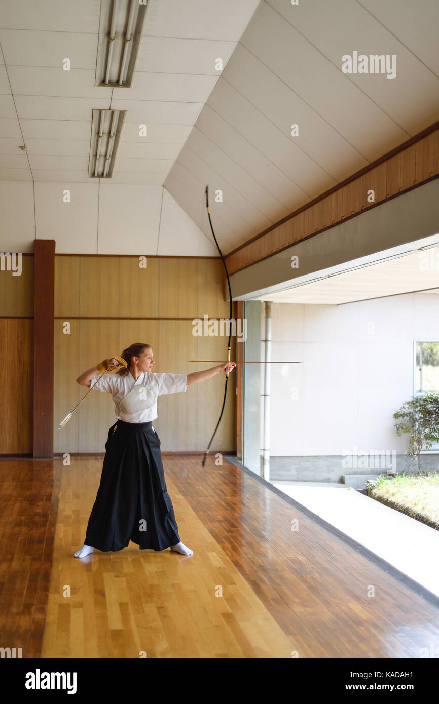 Caucasian woman practicing traditional Kyudo Japanese archery Stock ...