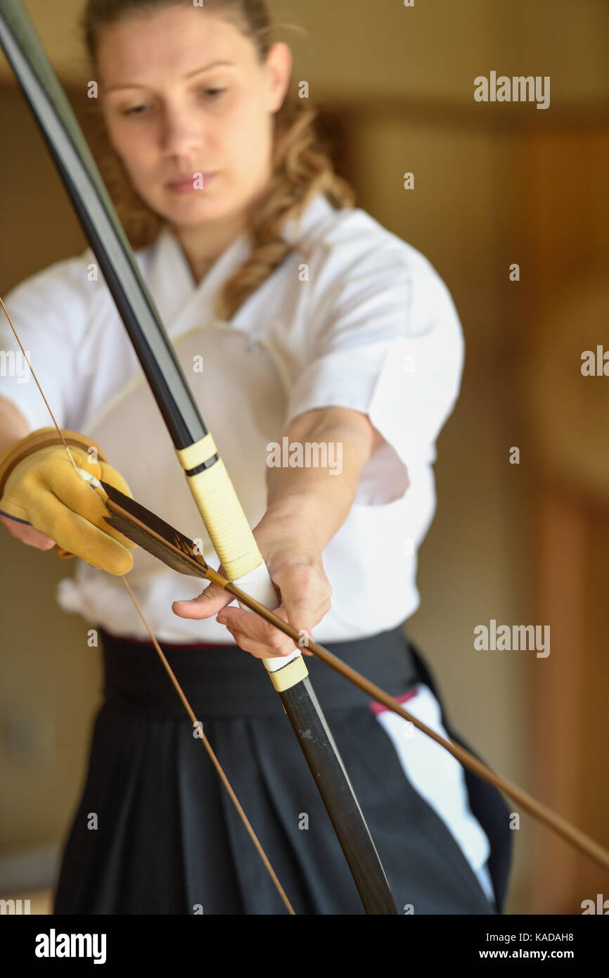 Caucasian woman practicing traditional Kyudo Japanese archery Stock ...