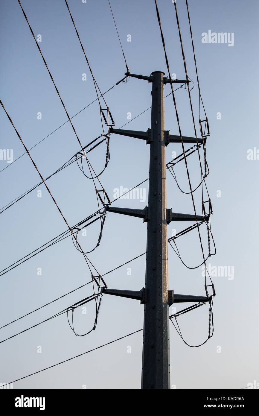 Tall powerline with 14 lines running through with the sky as background ...
